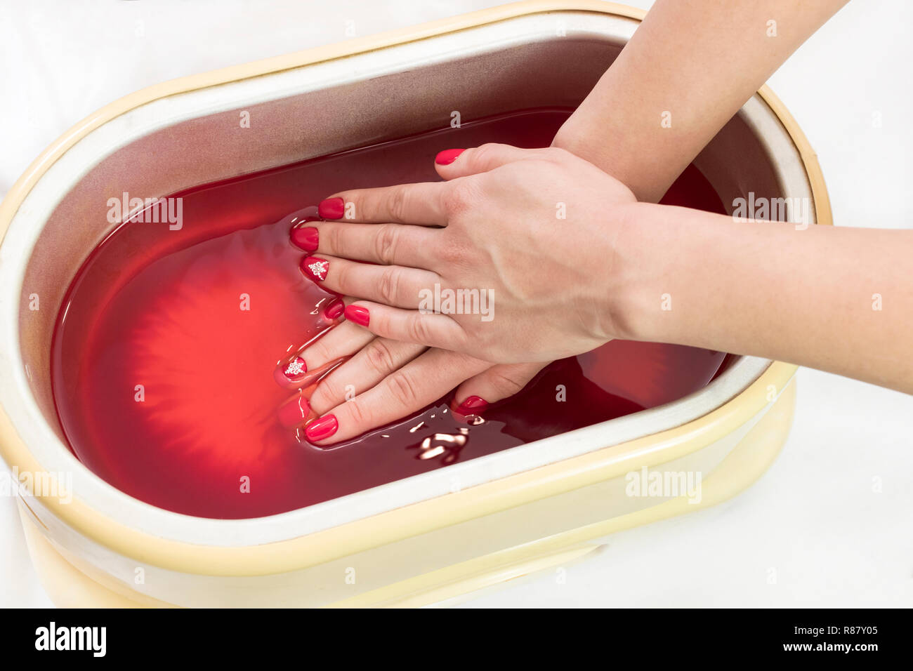 Process paraffin treatment of female hands in beauty salon Stock Photo ...