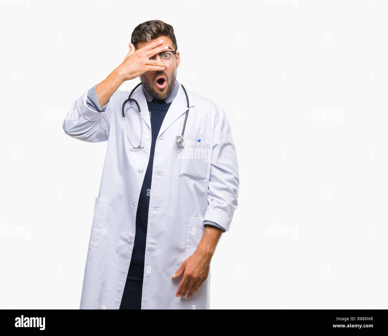 Young handsome doctor man over isolated background peeking in shock ...