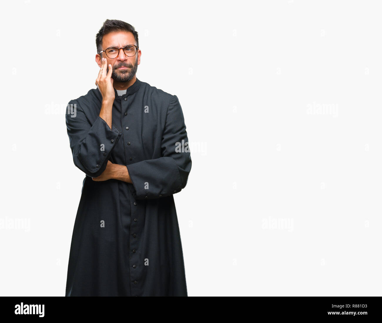 Adult hispanic catholic priest man over isolated background thinking ...