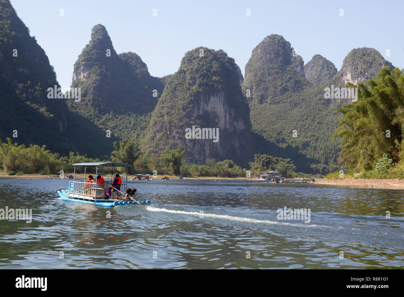 Raft on Li River in Guilin, China. Raft has 3 passengers, green ...