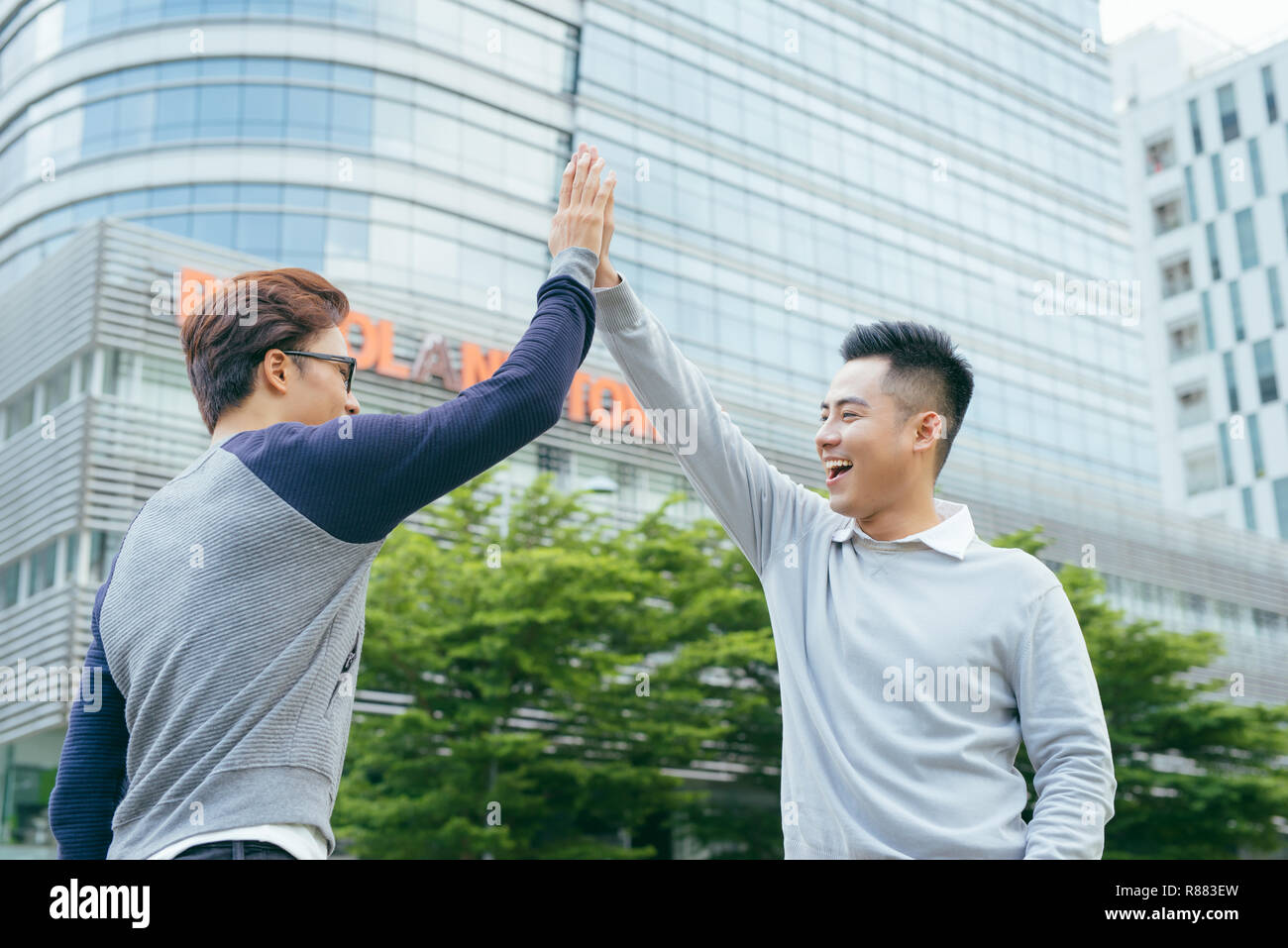 Two businessmen high fiving hi-res stock photography and images - Alamy