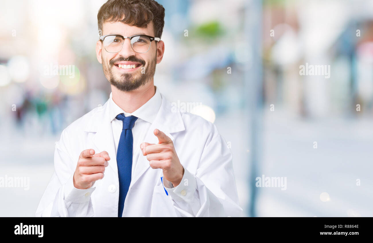Young professional scientist man wearing white coat over isolated ...