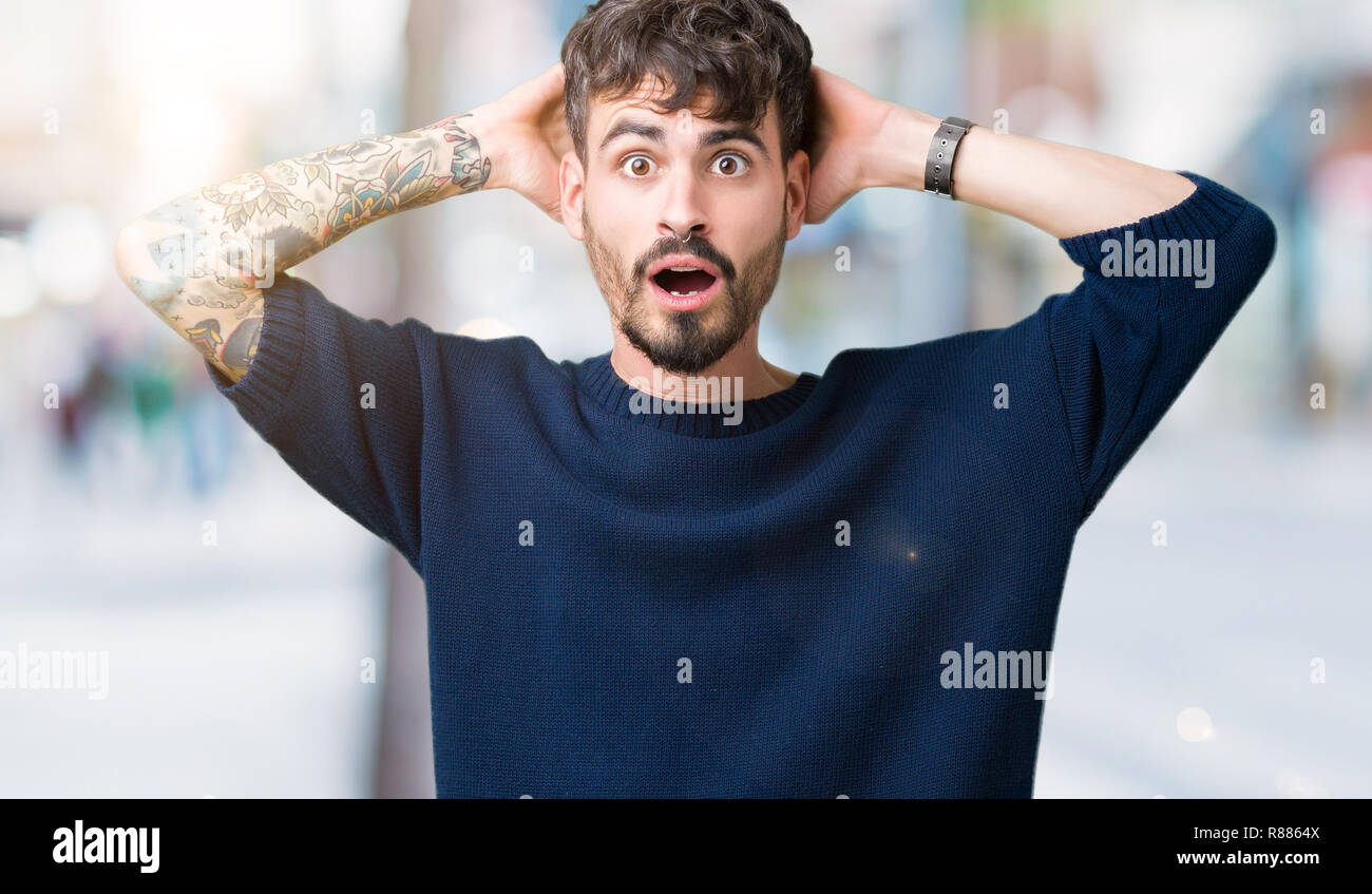 Young handsome man over isolated background Crazy and scared with hands ...