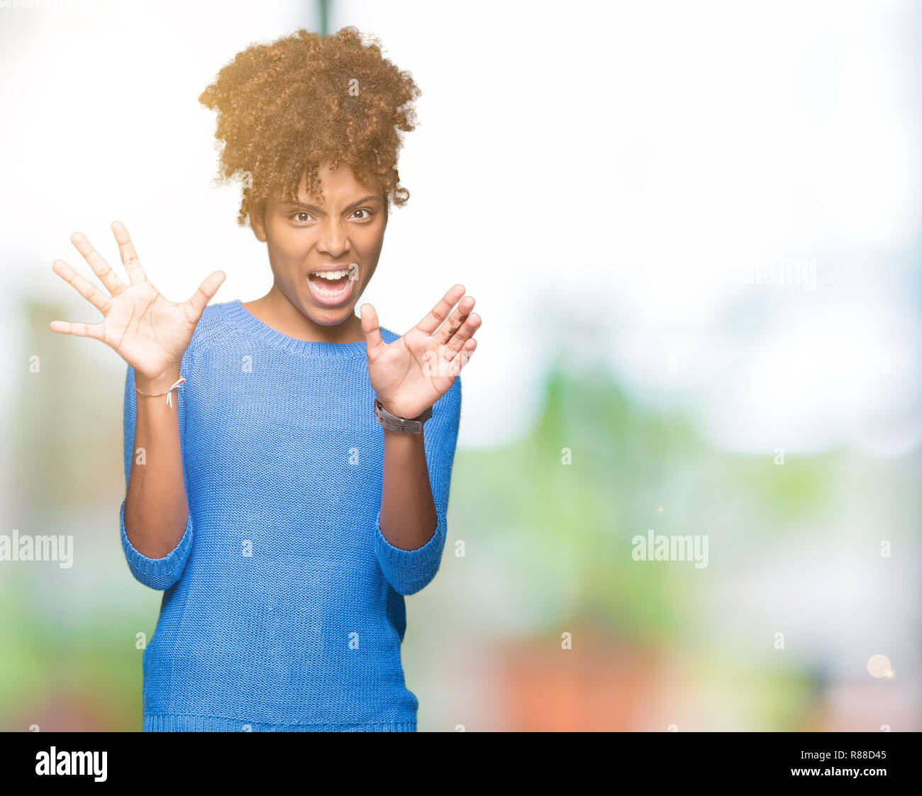 Beautiful young african american woman over isolated background afraid ...