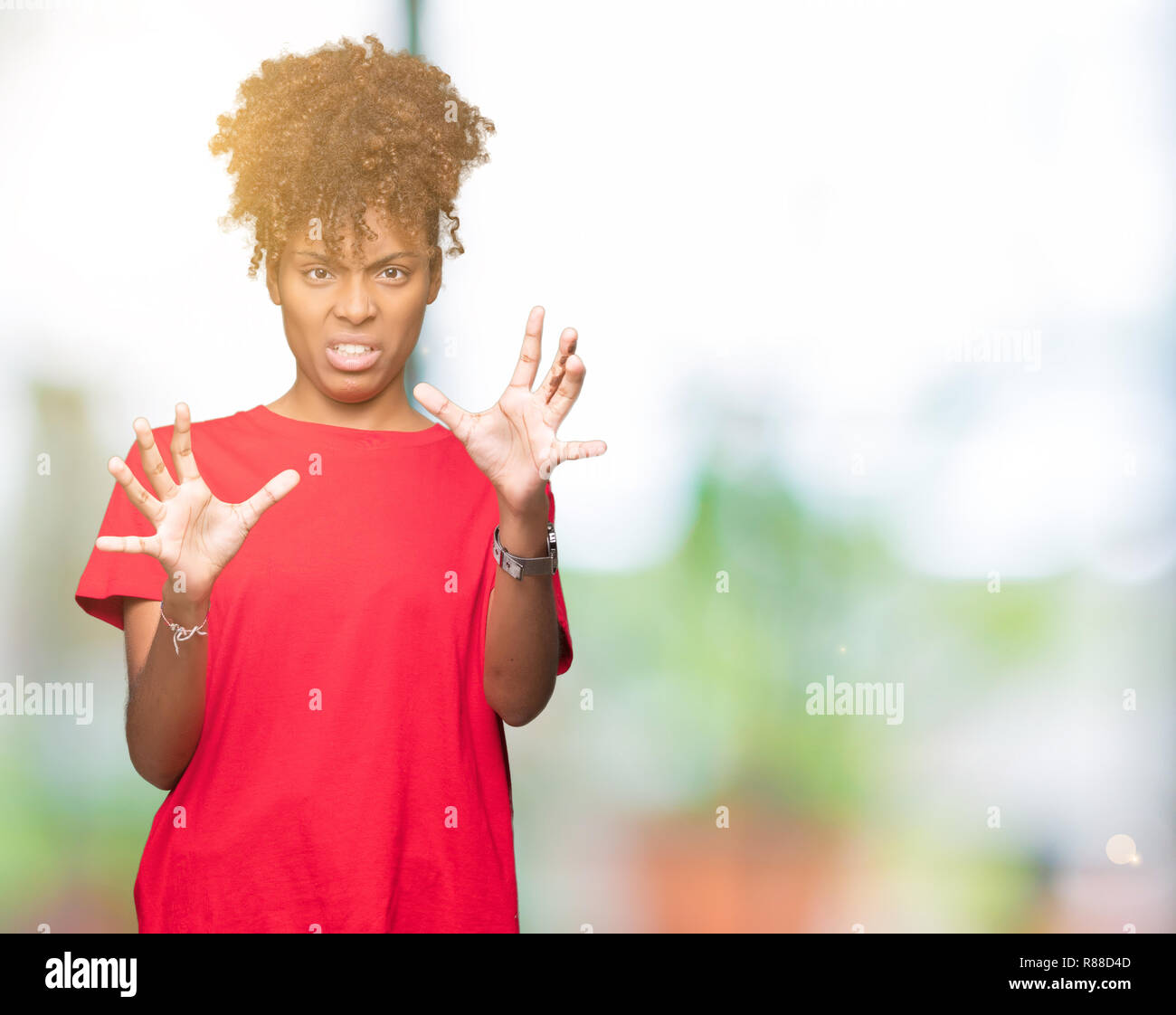 Beautiful young african american woman over isolated background afraid ...