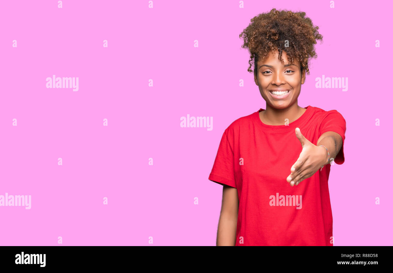Beautiful young african american woman over isolated background smiling ...