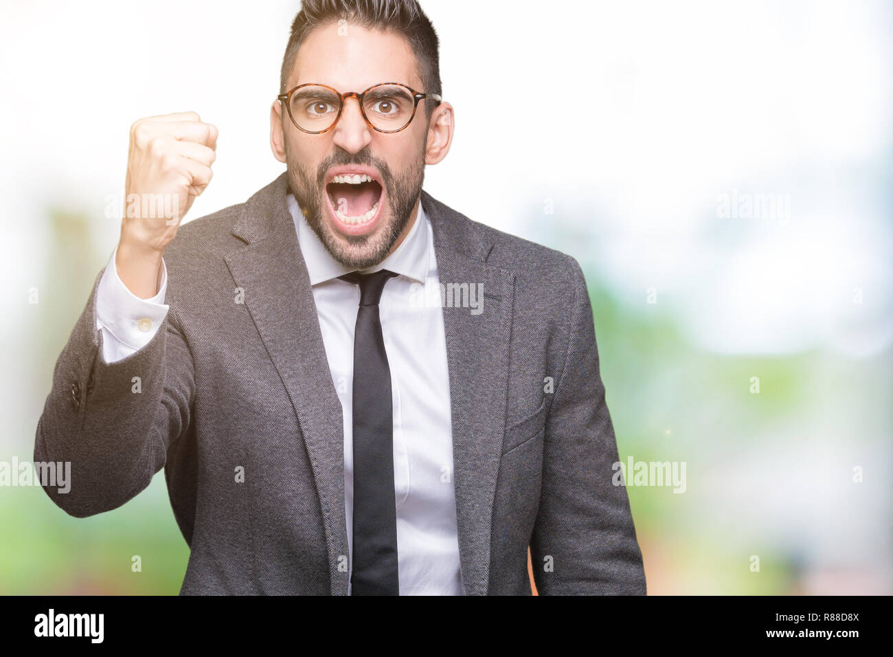 Young handsome business man over isolated background angry and mad ...