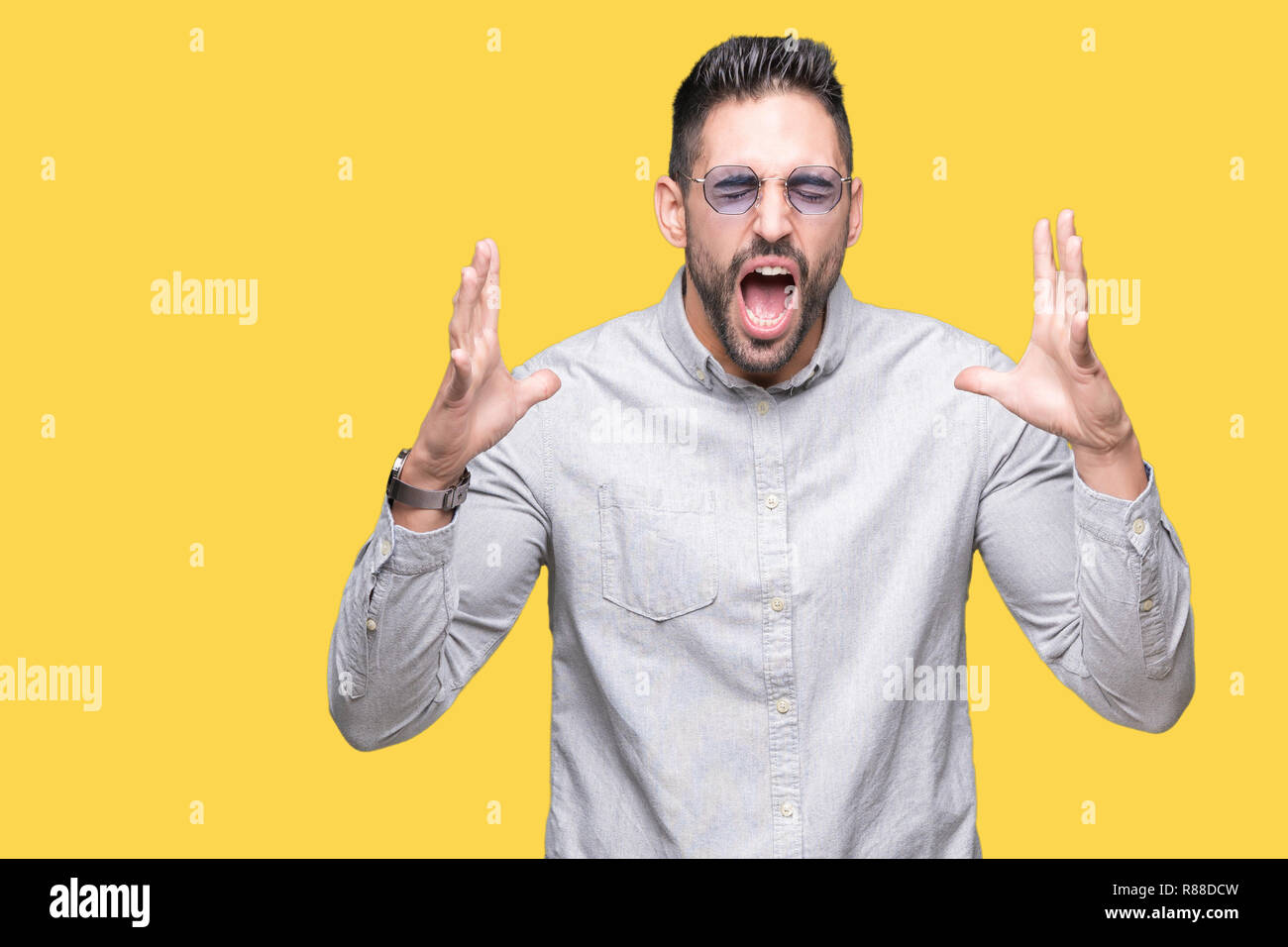 Young handsome man wearing sunglasses over isolated background ...