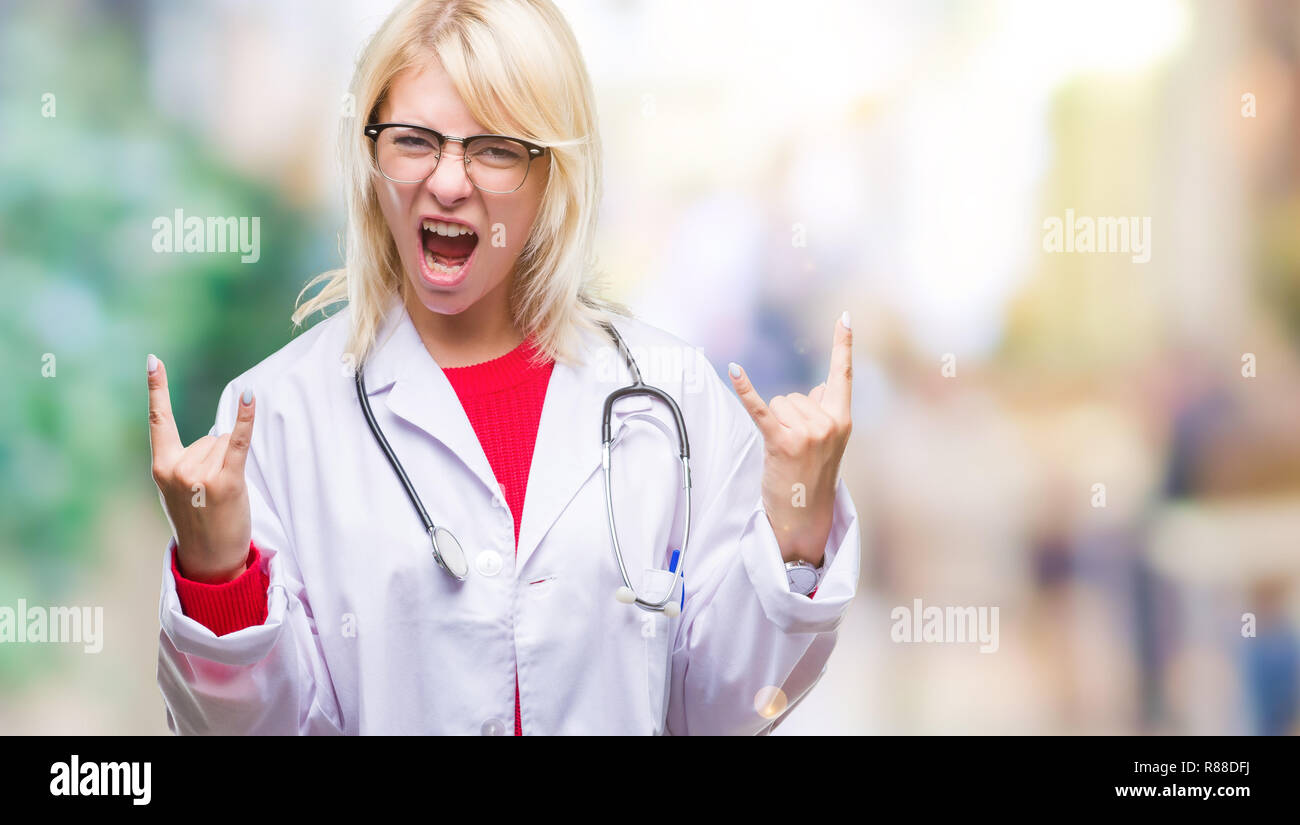 Young beautiful blonde doctor woman wearing medical uniform over ...