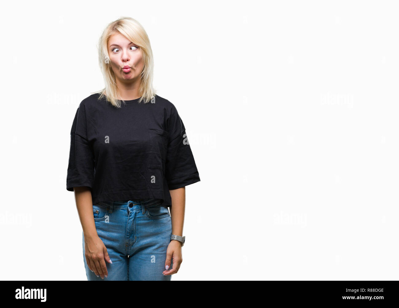 Young beautiful blonde woman over isolated background making fish face ...