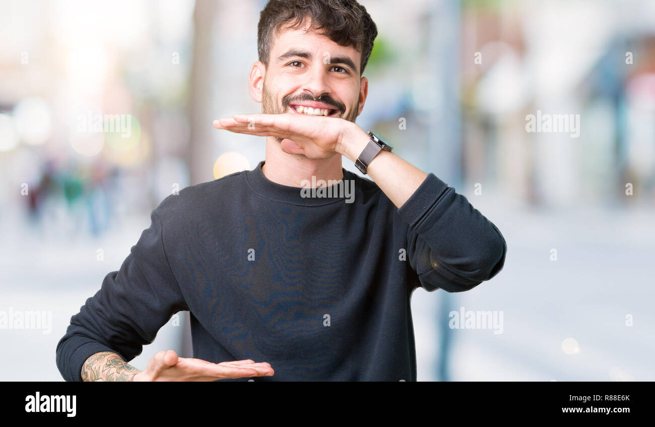 Young handsome man over isolated background gesturing with hands ...
