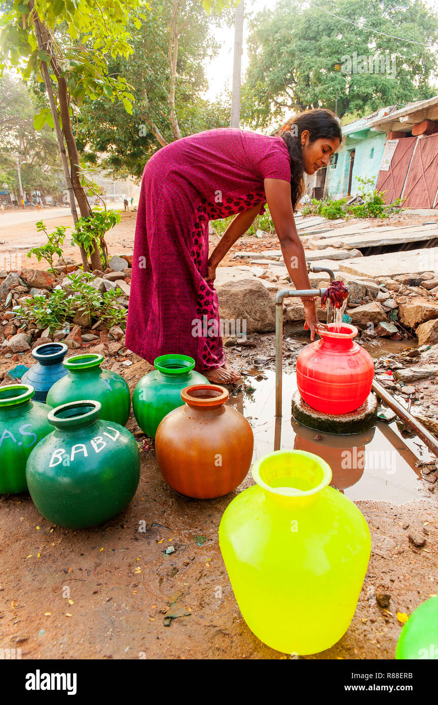 Young indian woman collecting water at Bazaar Street, Hampi, Karnataka ...