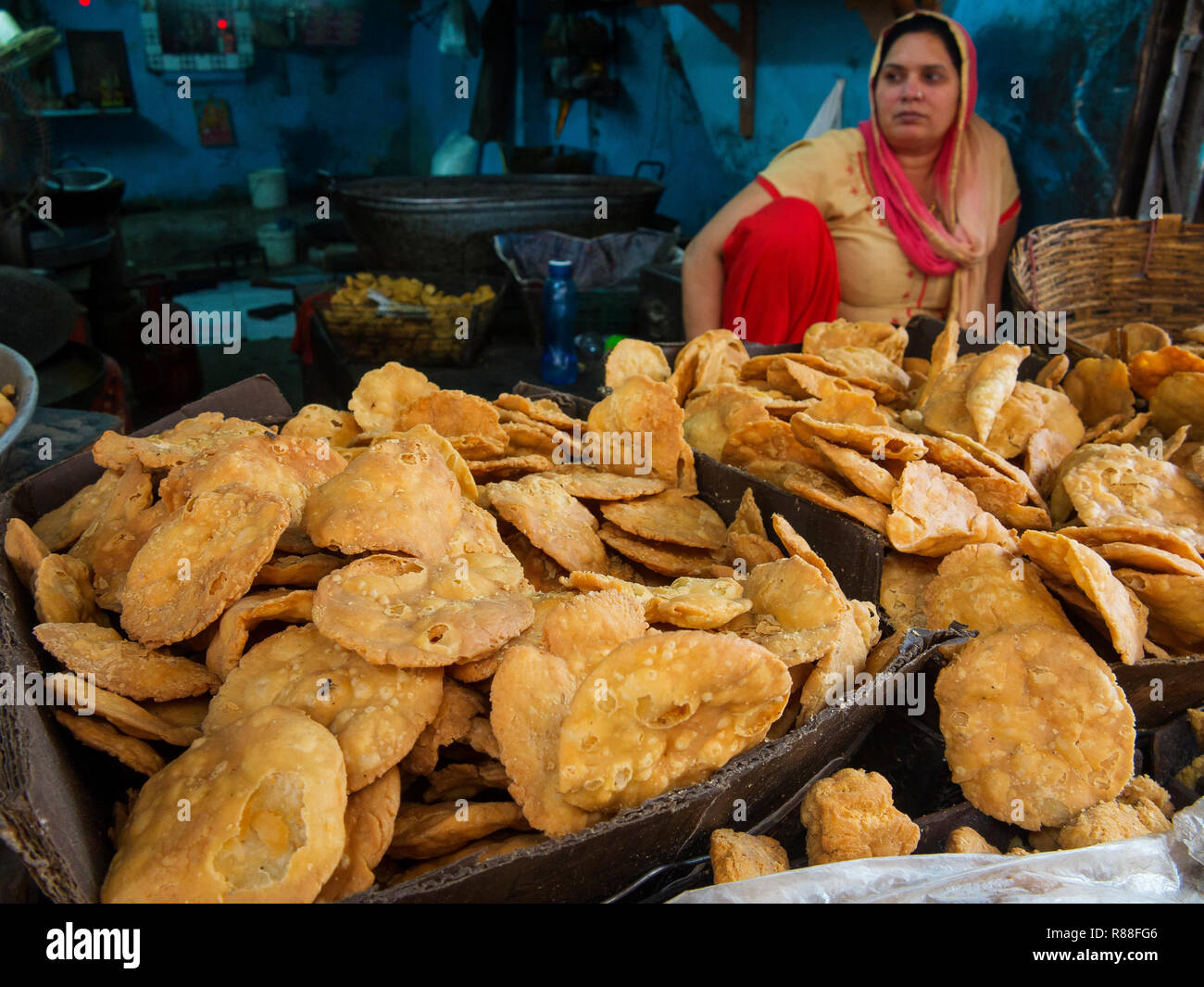 Indian woman selling traditional indian snacks at Sangatrashan Bazar ...