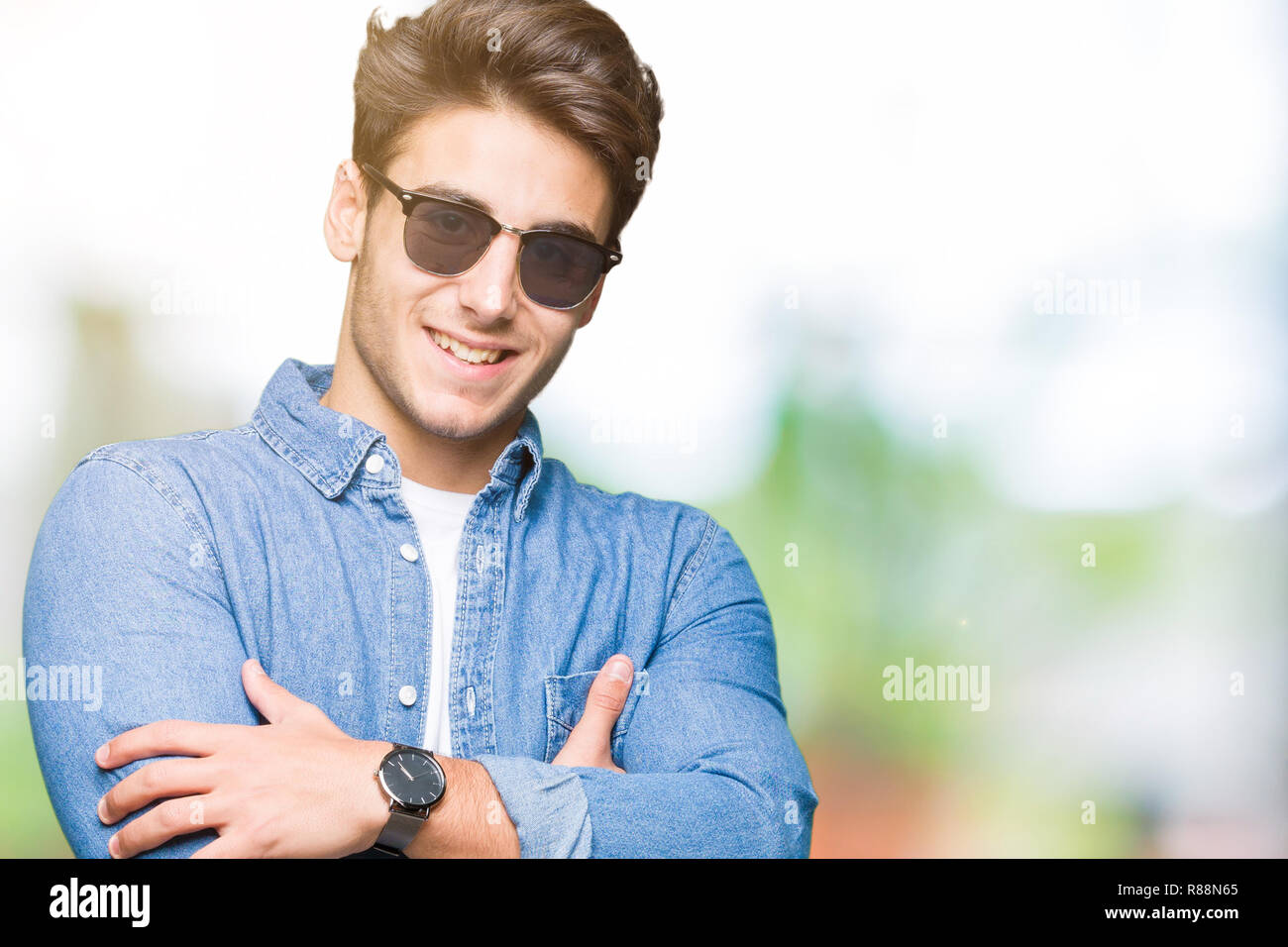 Young handsome man wearing sunglasses over isolated background happy ...