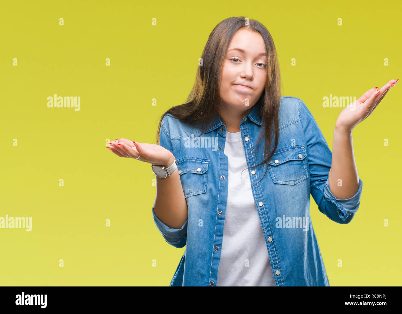 Young caucasian beautiful woman over isolated background clueless and ...