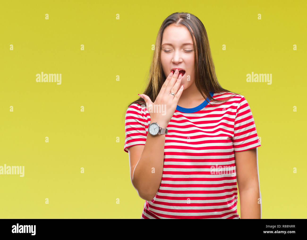 Young caucasian beautiful woman over isolated background bored yawning ...