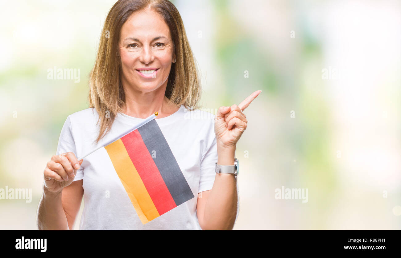 Middle age hispanic woman holding flag of Germany over isolated ...