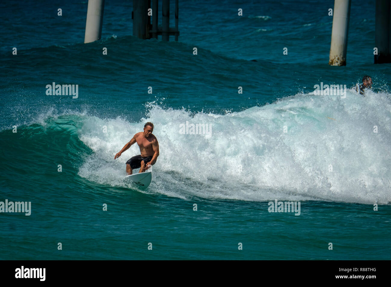 Surfers near the Sand Pumping Jetty, The Spit Stock Photo - Alamy