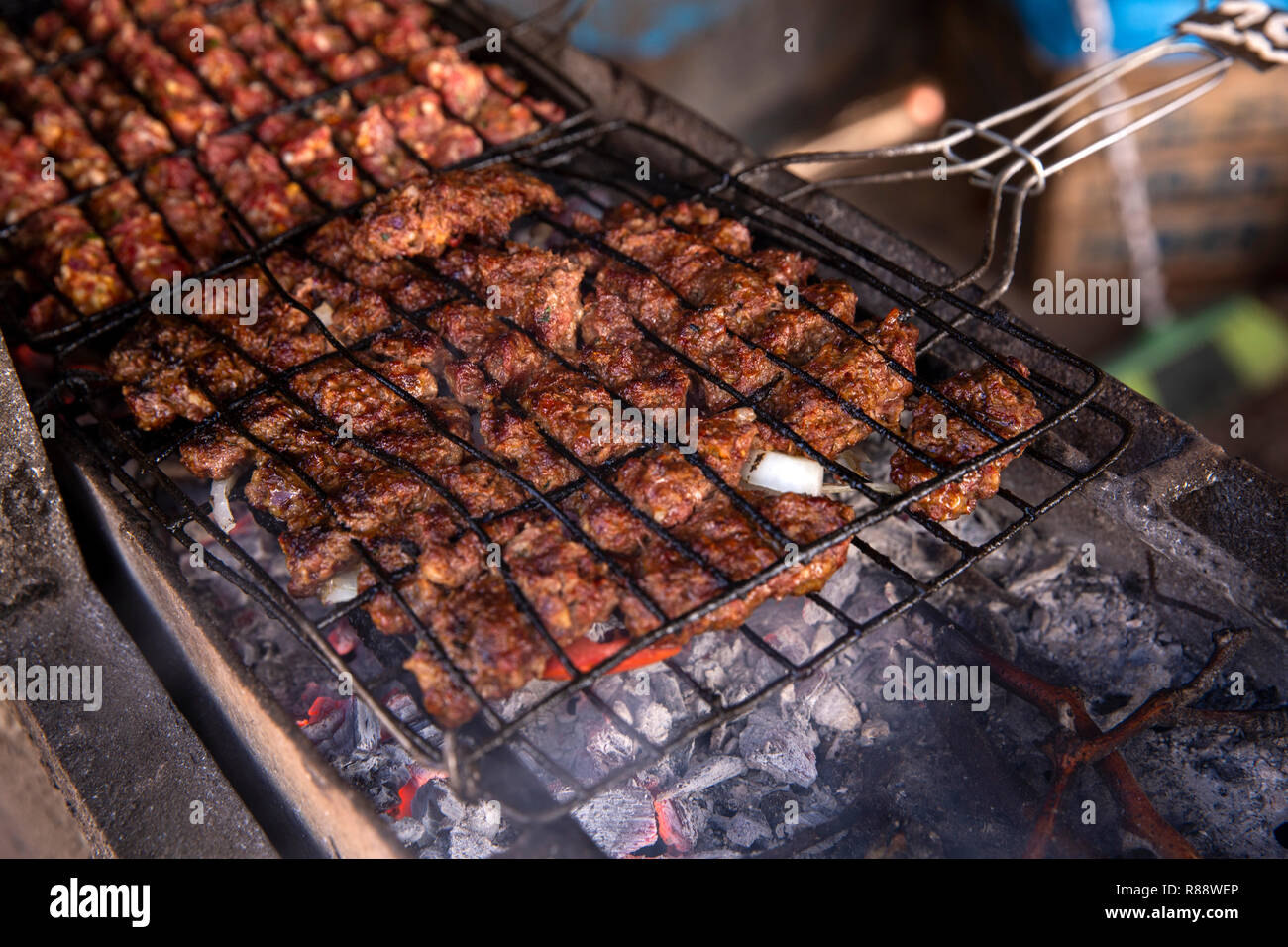 Morocco, Errachidia, meat cooking on hot charcoal barbecue in small ...