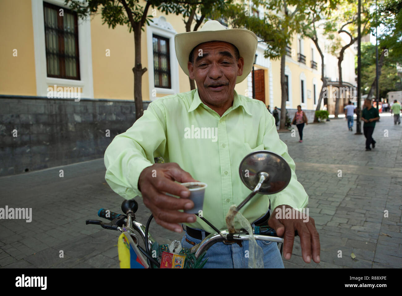 Male street vendor wearing cowboy hat selling refreshments in Bolivar ...