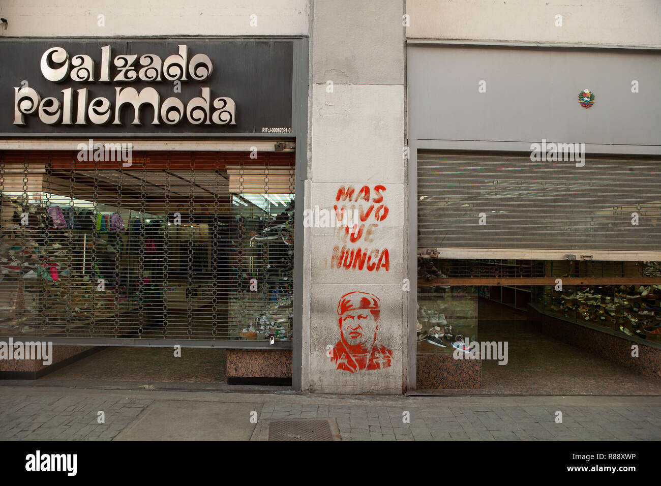Political spray paint graffiti between shop fronts, Caracas, Venezuela ...