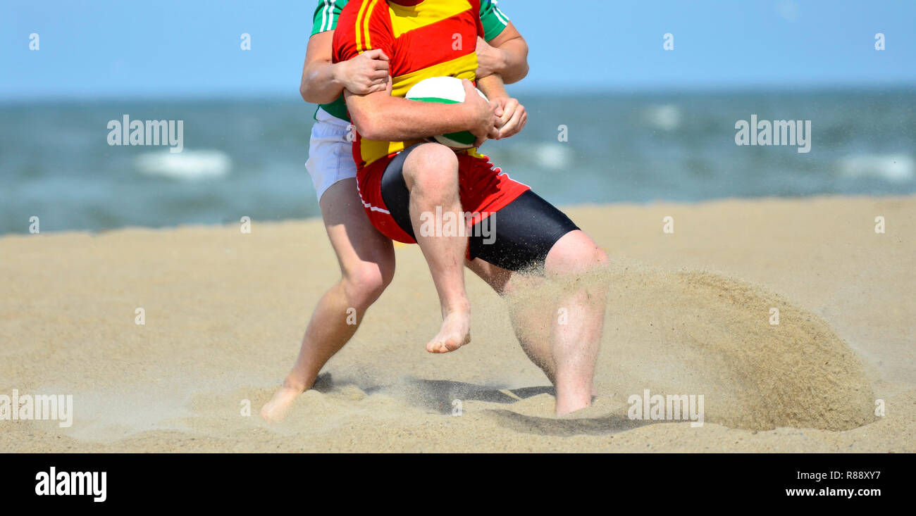 Playing rugby at the beach. Team sport Stock Photo - Alamy