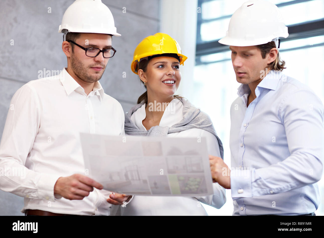 Group of architects sharing ideas in modern office Stock Photo - Alamy