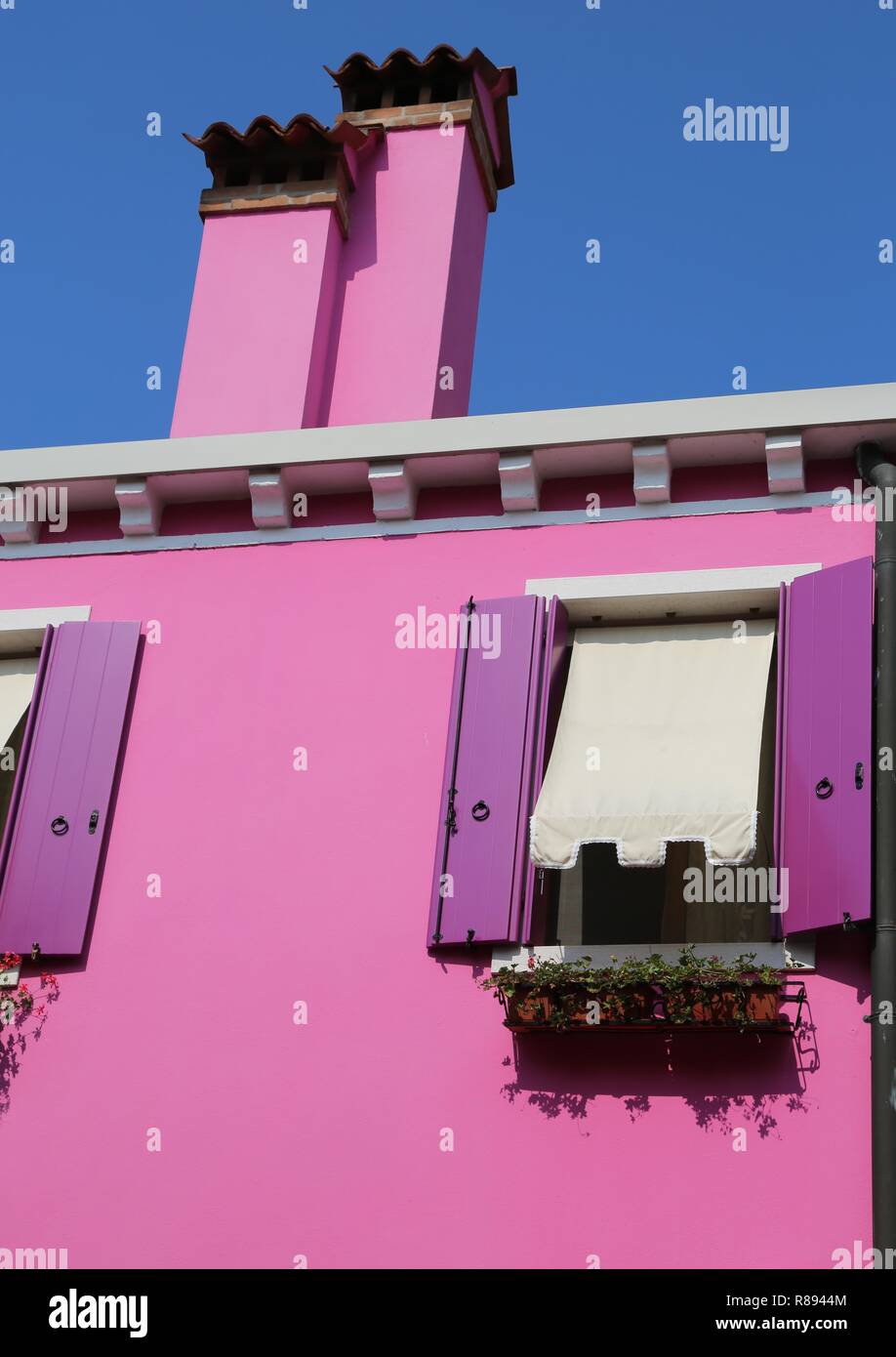 Magenta house with purple balconies in a small Mediterranean town Stock ...