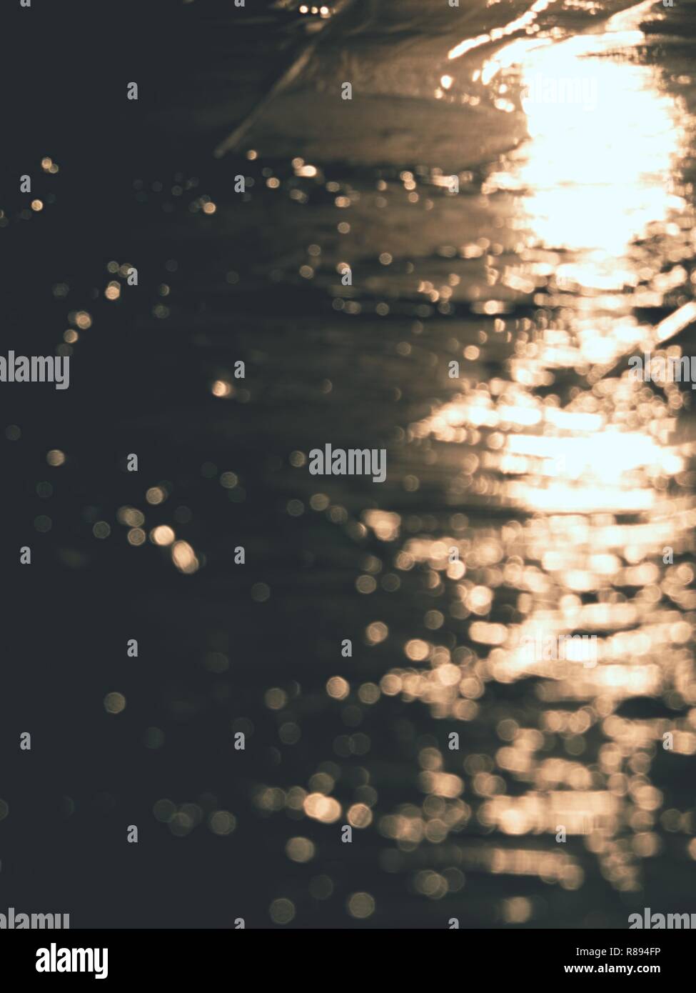 Ice cover is melting under the warm sun with bright rays reflecting in ...