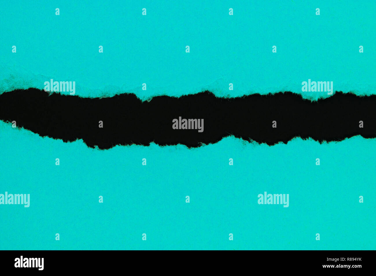 Light blue ripped paper placed on black background paper with copy ...