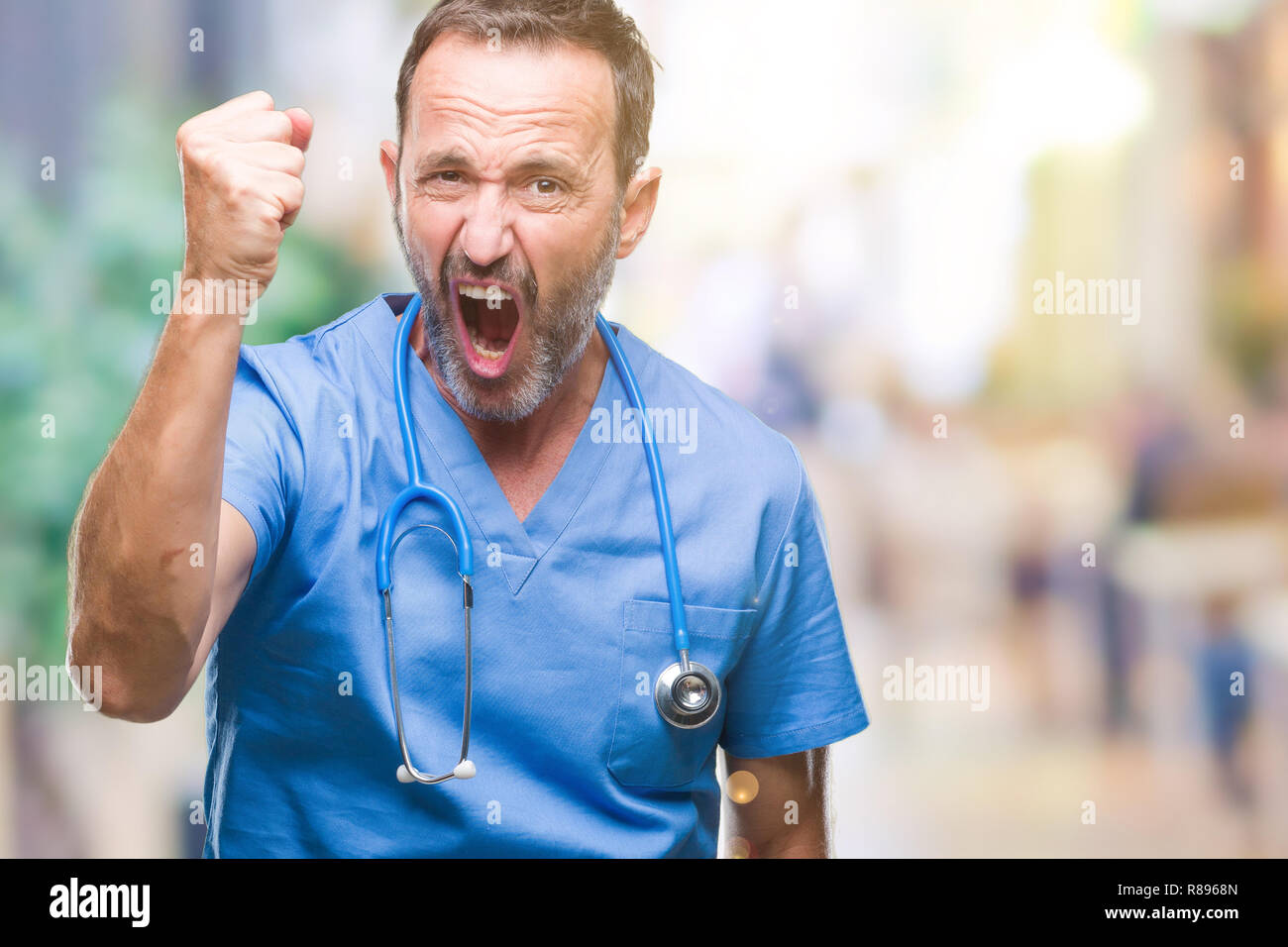 Middle age hoary senior doctor man wearing medical uniform over ...