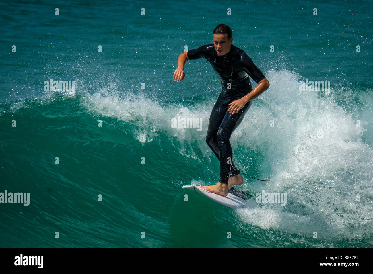 Surfers near the Sand Pumping Jetty, The Spit Stock Photo - Alamy