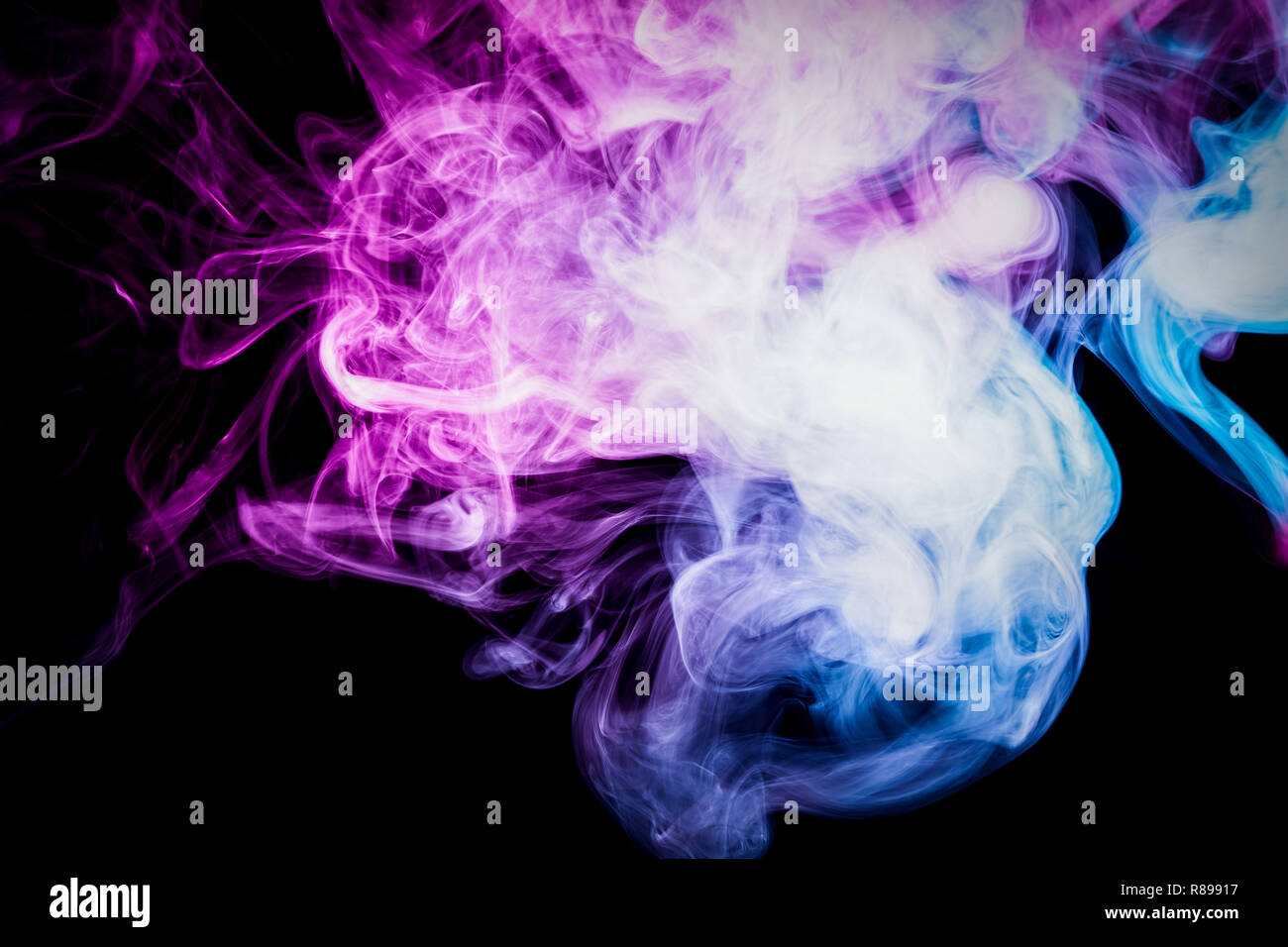 Pink and blue cloud of smoke of black isolated background. Background ...