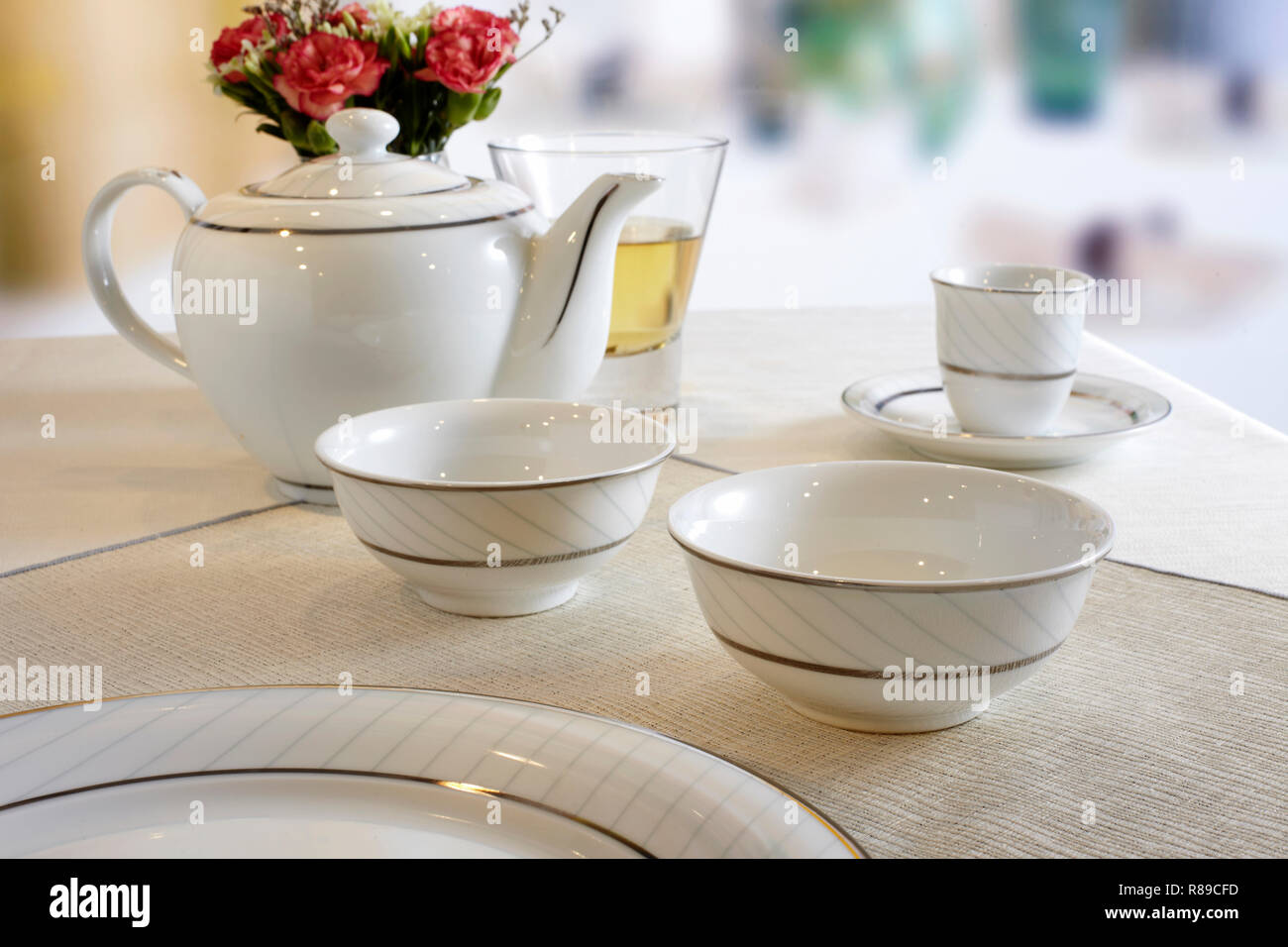 Ceramic tableware on white table Stock Photo - Alamy