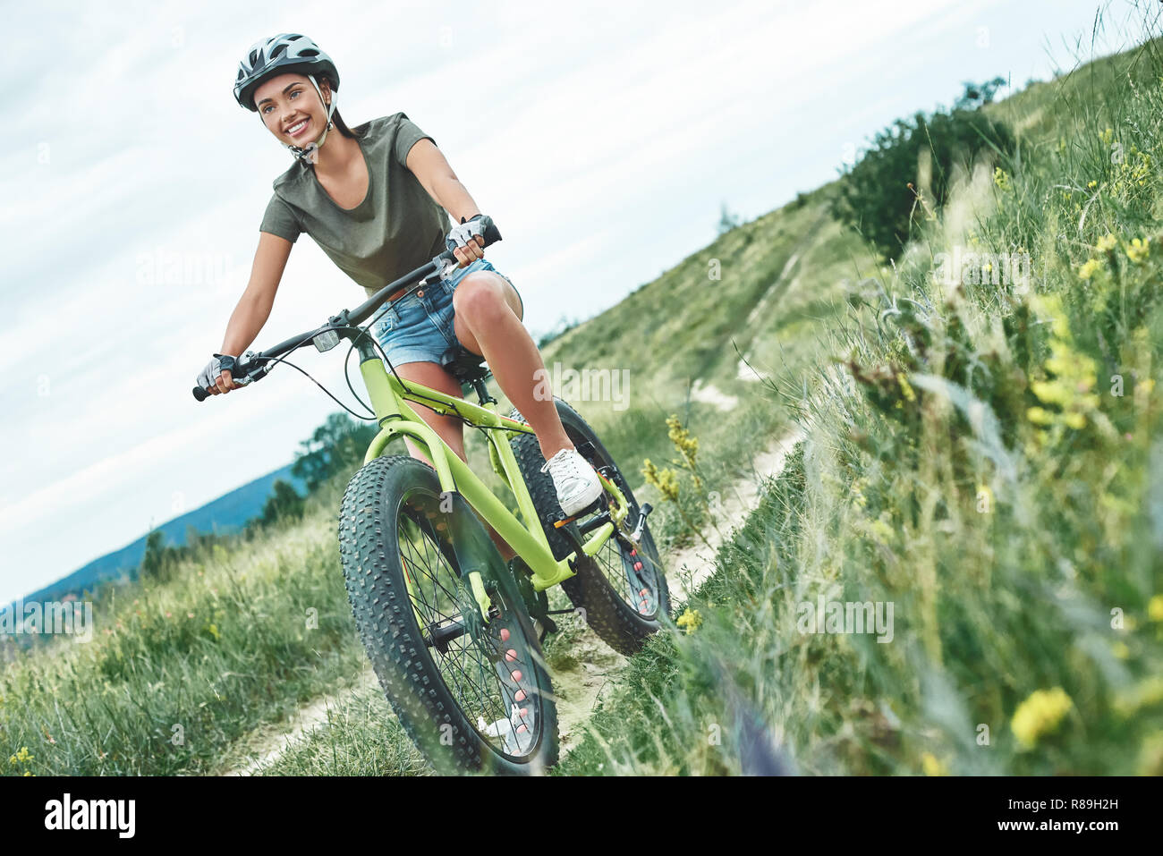Mountain biking - woman with fatbike enjoys summer vacation. Bottom ...