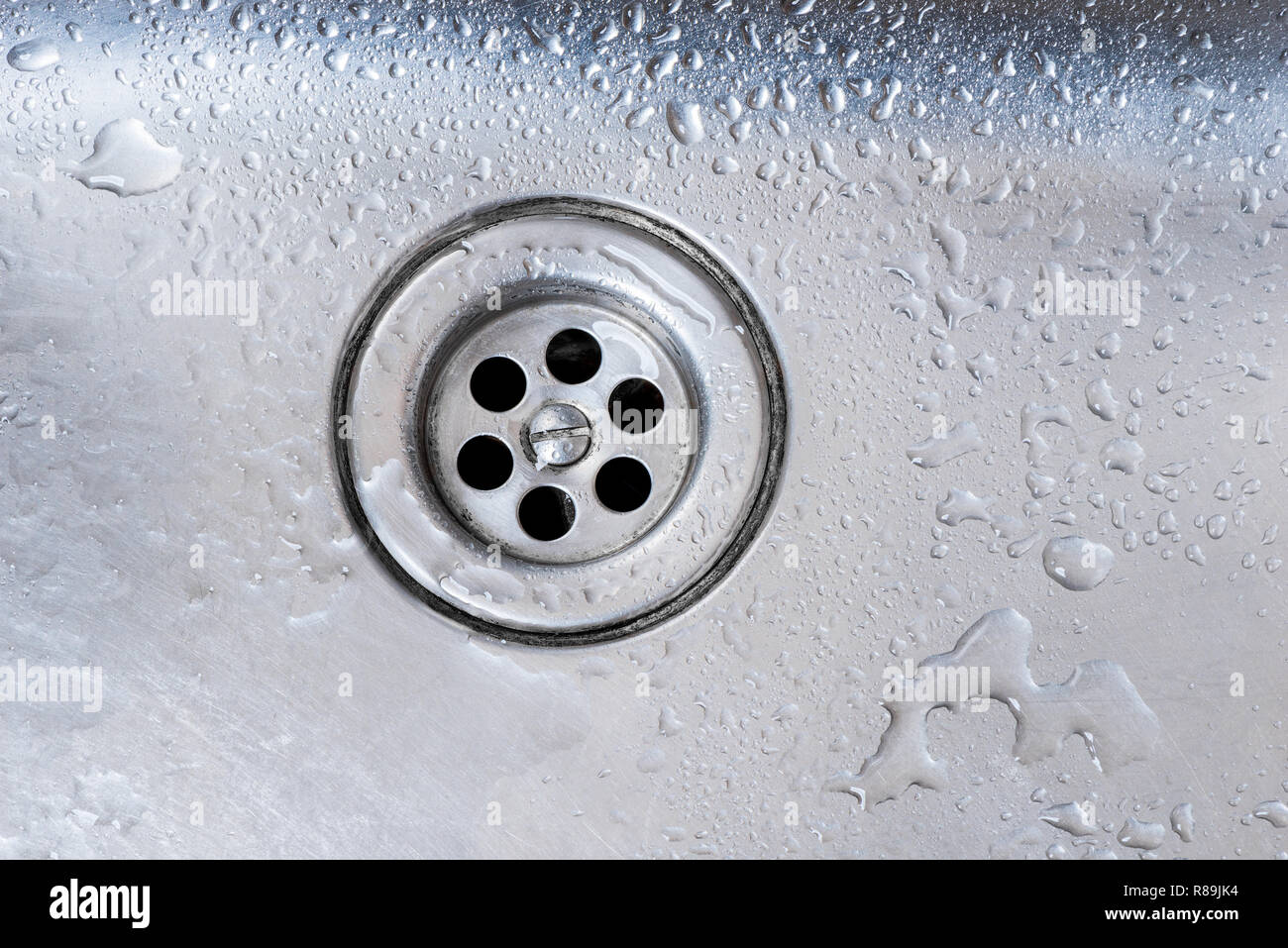 drain of stainless kitchen sink close up Stock Photo - Alamy