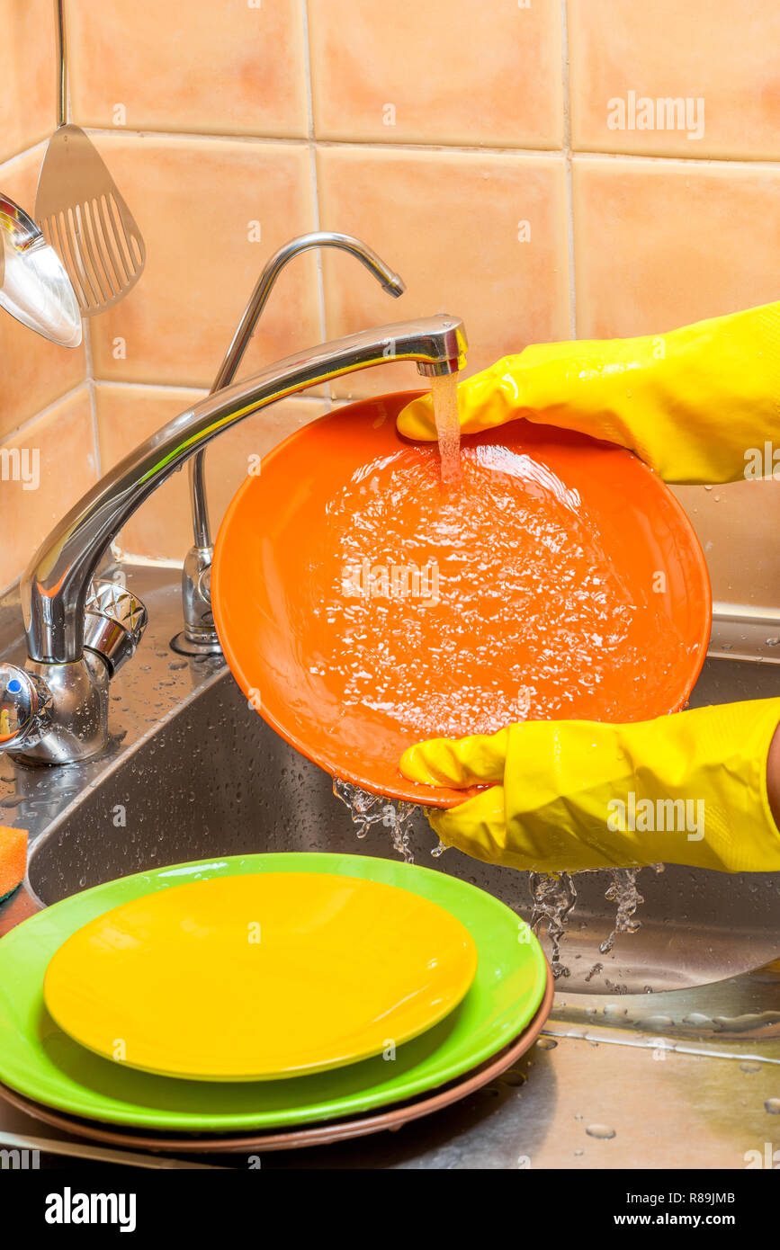 woman washing dishes in the kitchen - vertical photo Stock Photo - Alamy