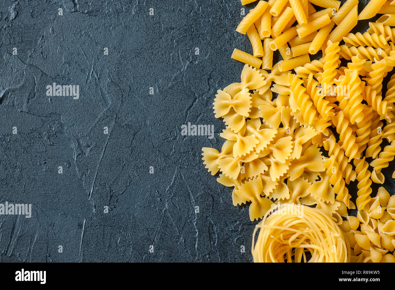 Variety of types of Italian pasta background. Set of raw dry pasta on a ...