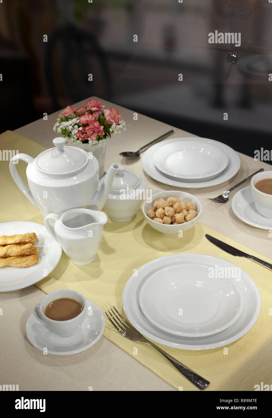 Ceramic tableware on white table Stock Photo - Alamy