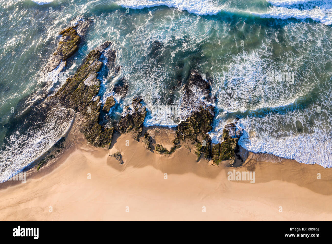 Aerial view of waves running across the rocks at Dudley Beach ...