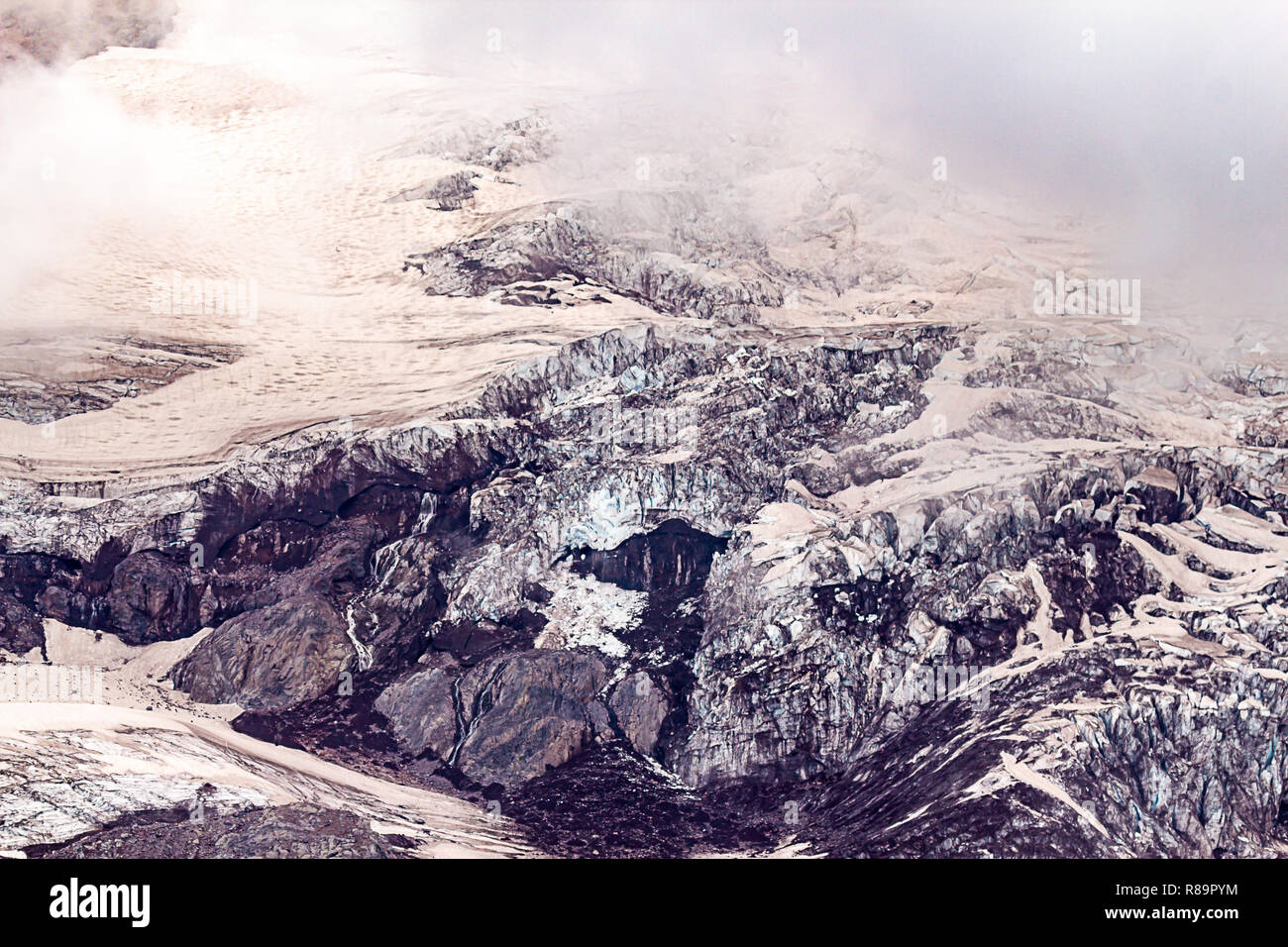 a cold misty mountain top covered in snow and clouds Stock Photo - Alamy