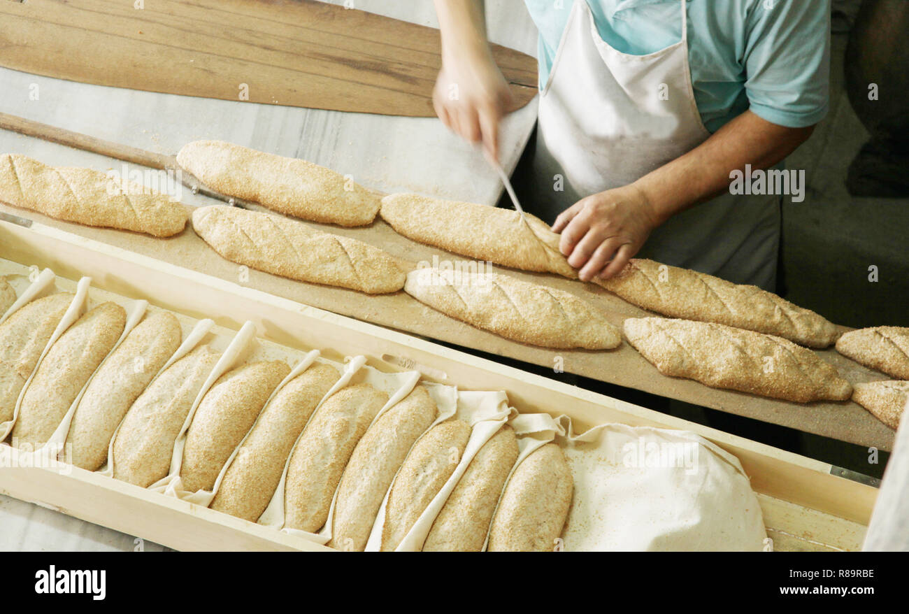 Baker baking bread Stock Photo - Alamy
