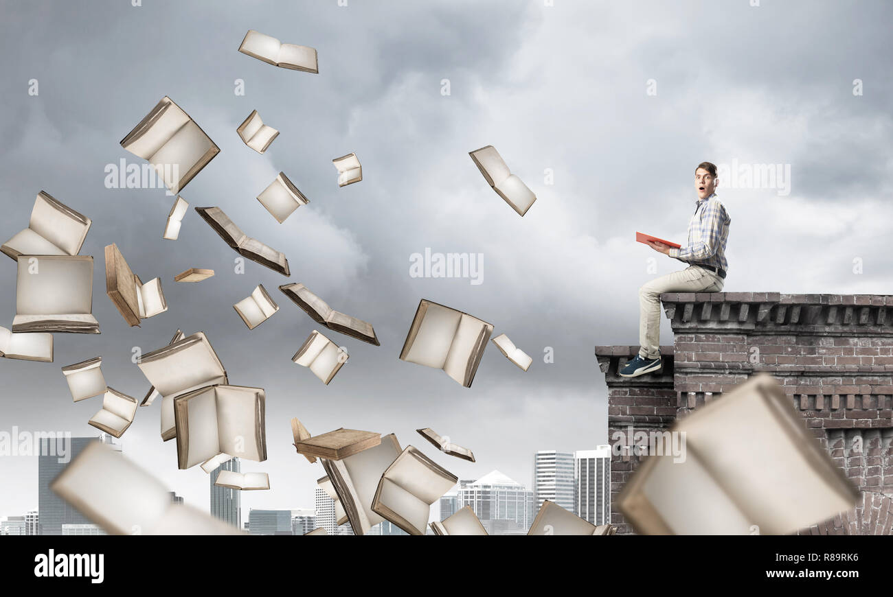 Man reading book and many of them flying in air Stock Photo - Alamy