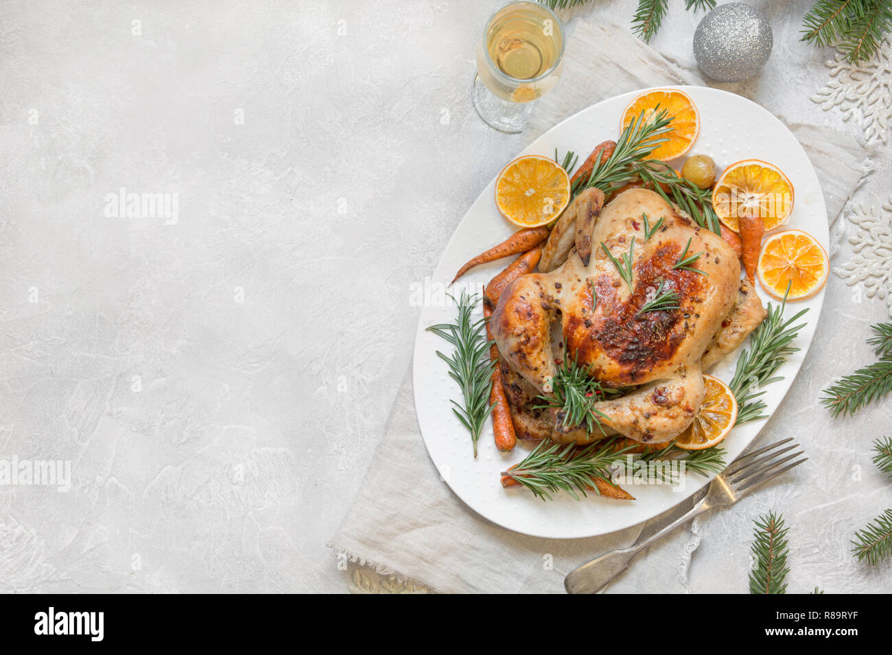 Traditional Christmas roasted chicken garnish orange, carrot, and ...
