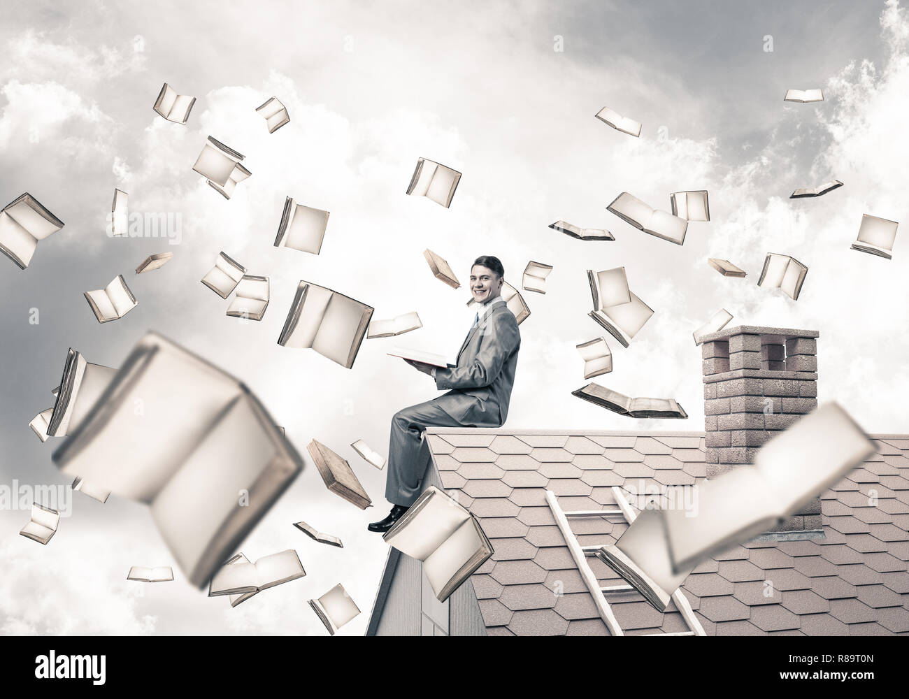 Man reading book and many of them flying in air Stock Photo - Alamy