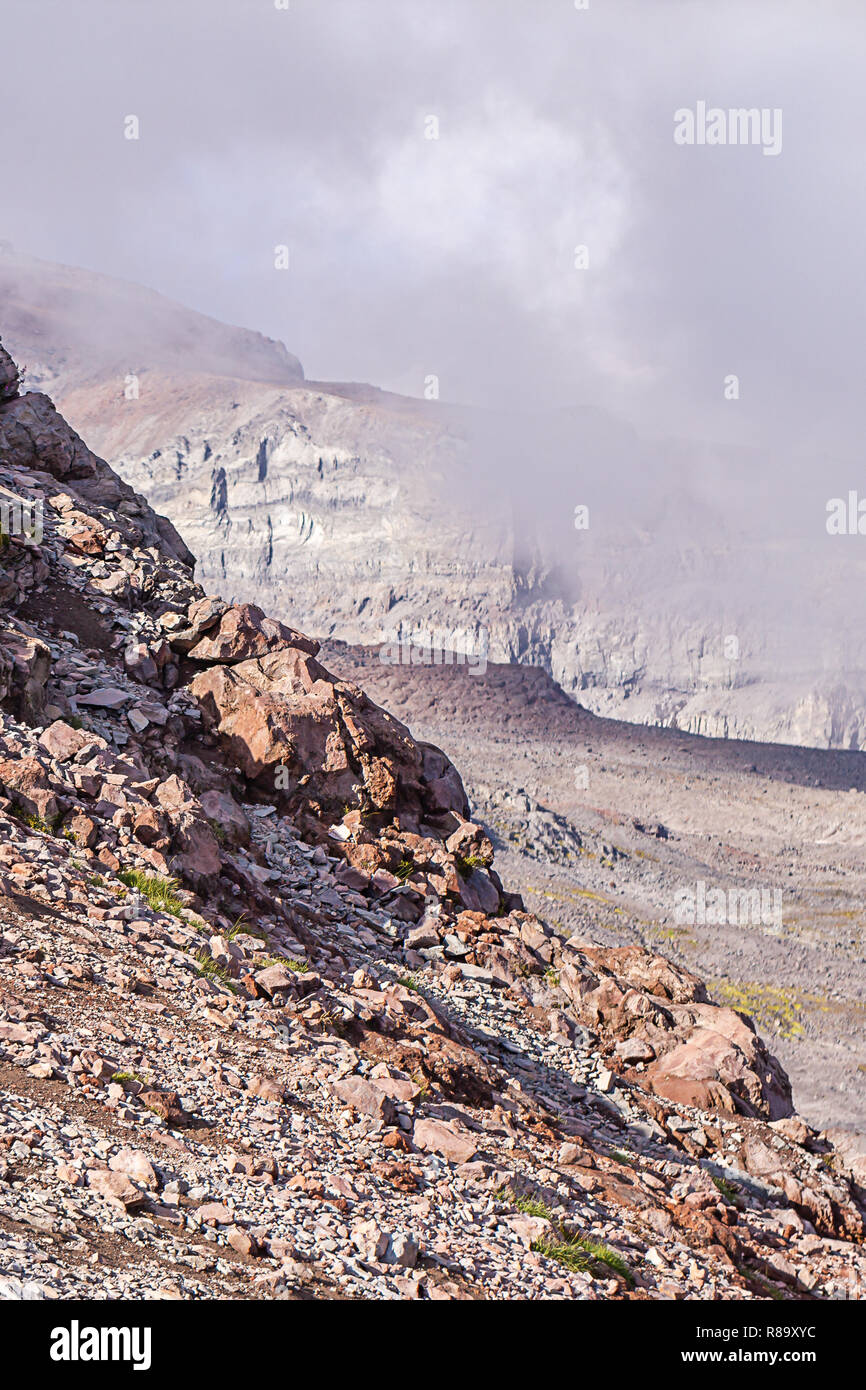 shards of rock and stone along volcanic mountain sides with clouds ...
