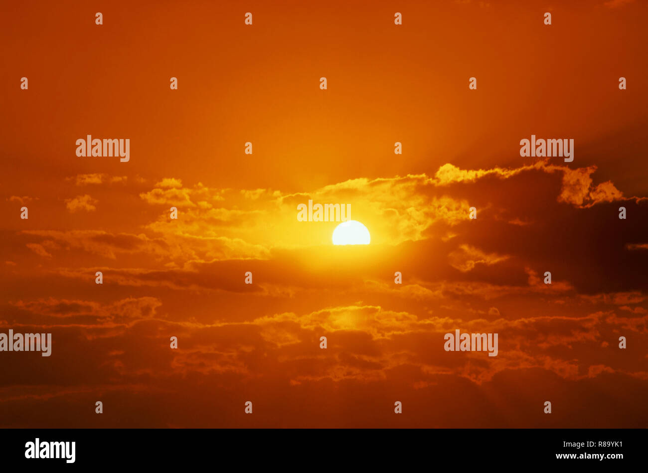 sun hiding behind cloudy sky at sunset, hyderabad, andhra pradesh ...