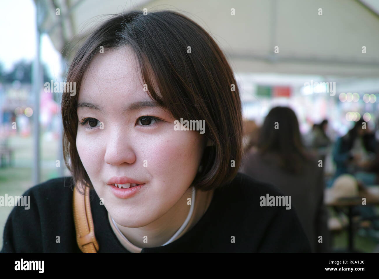 A young lady lookng slightly exasperated off camera with copy space on ...