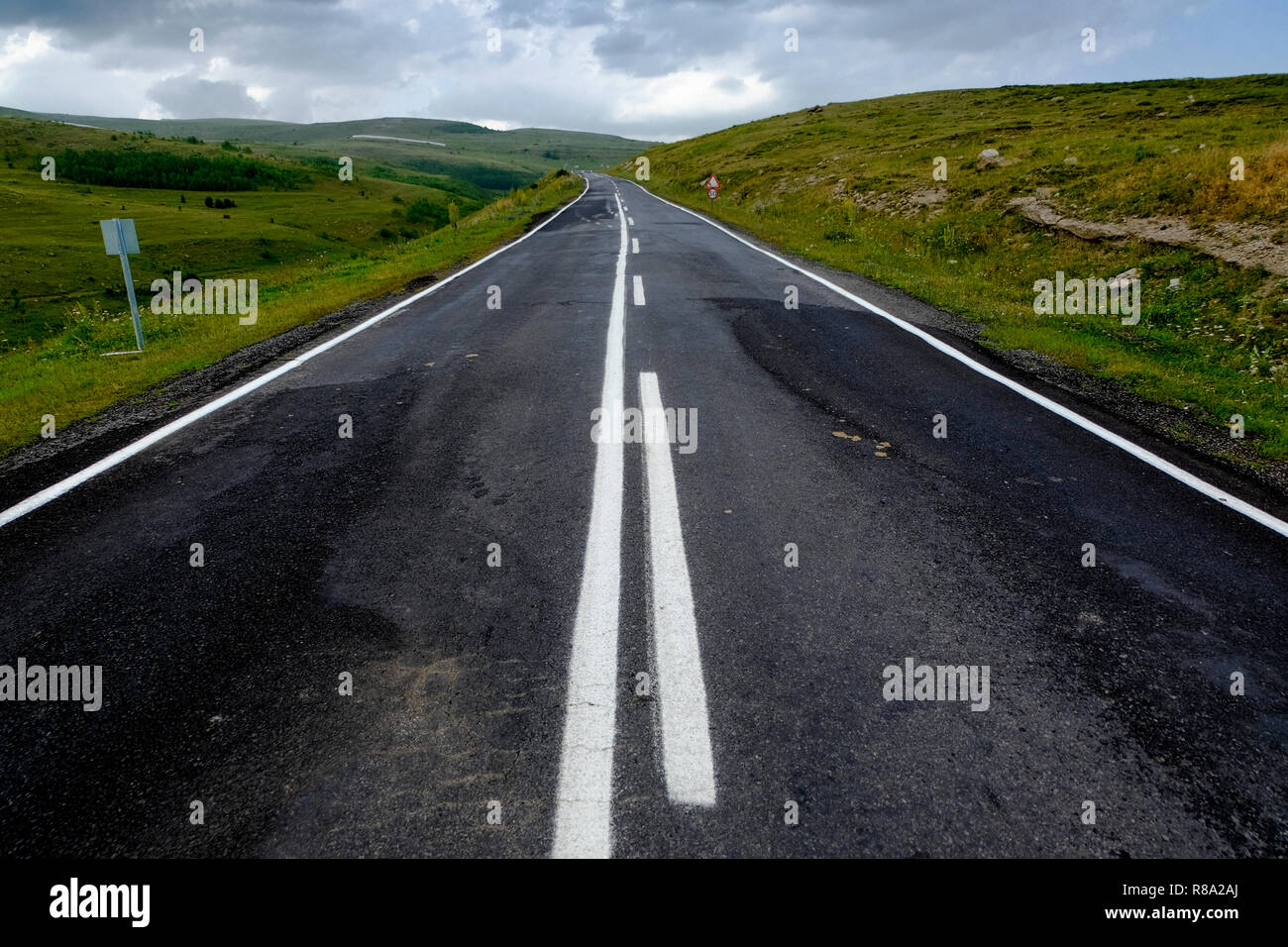 Long asphalt road between valleys Stock Photo - Alamy