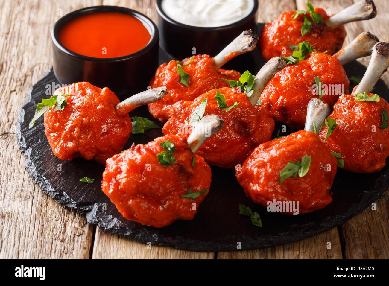 Buffet menu of Lollipops deep-fried red chicken wings served with ...
